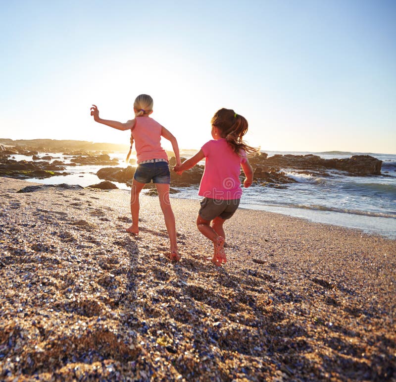 Playtime at the Beach. Two Little Girls Having Fun on the Beach. Stock ...