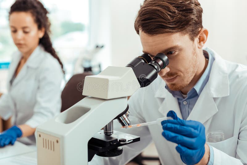 Top View of a Smart Man Looking into the Microscope Stock Image - Image ...