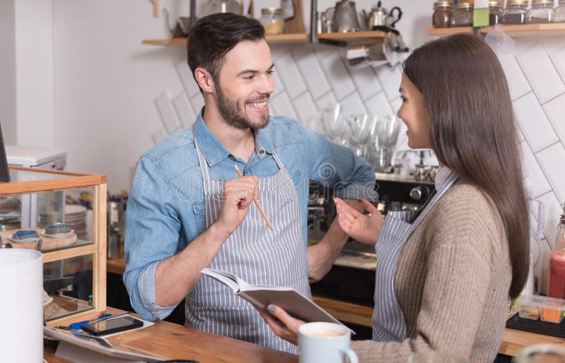 Pleasant Couple Talking at the Counter Stock Photo - Image of jester ...