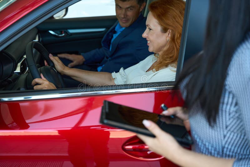 Pleasant Couple Testing Interior Car from the Inside in Car Center ...