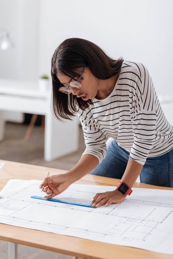 Pleasant Female Engineer Working on a Blueprint Stock Image - Image of ...
