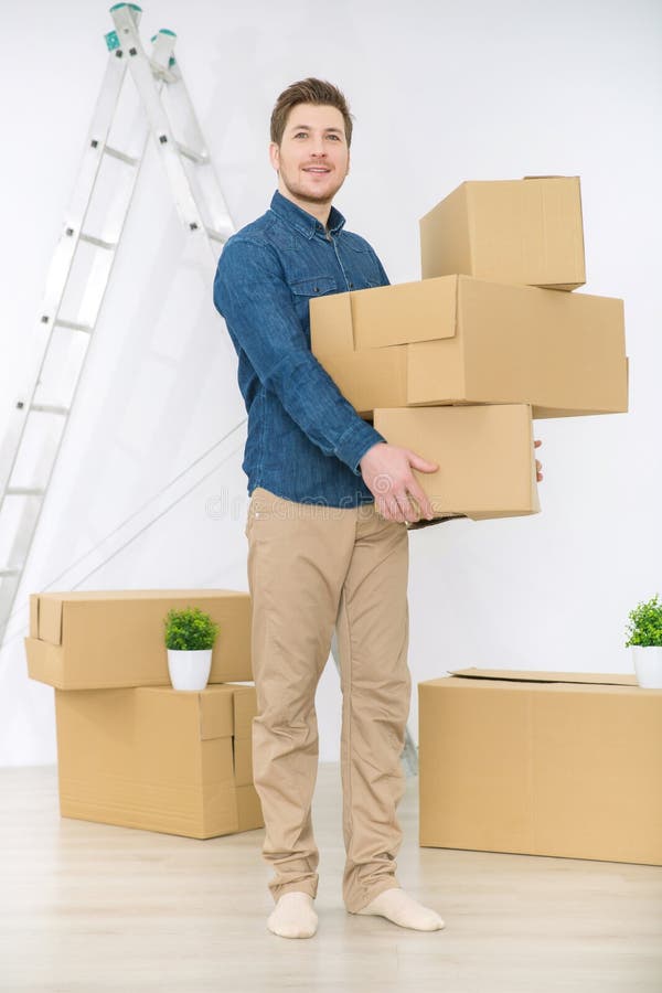 Pleasant man holding boxes stock photo. Image of house - 65871218