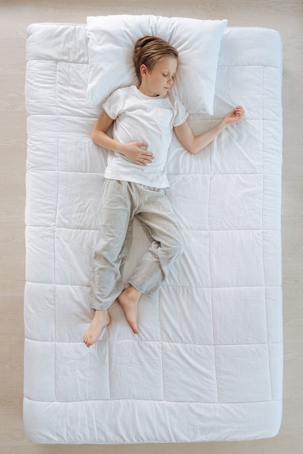 Pleasant Nice Boy Having a Rest Stock Photo - Image of bedtime, bedding ...