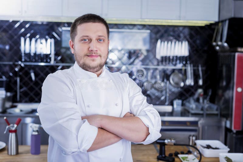 Pleasant Nice Cook Standing in the Middle of the Kitchen Stock Image ...