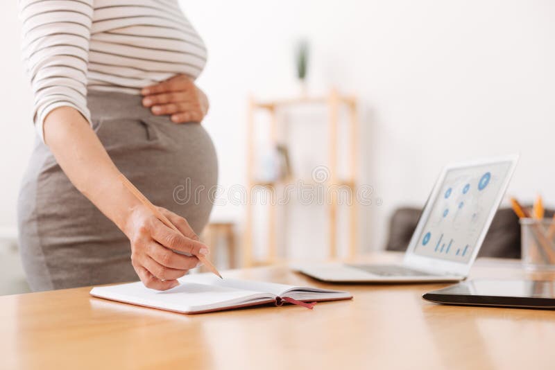 Pleasant Pregnant Woman Making Notes in the Office Stock Image - Image ...