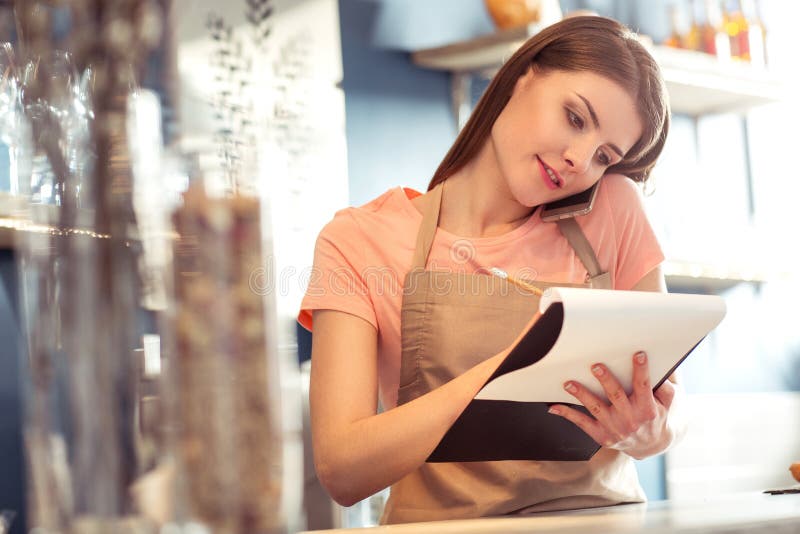 Pleasant Waitress Talking on Mobile Phone Stock Photo - Image of paper ...