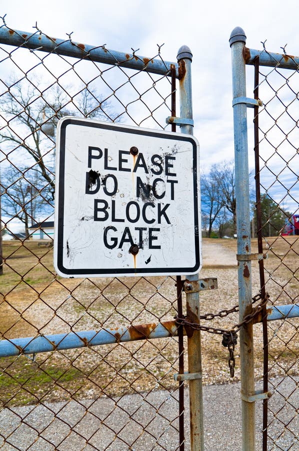Please Do Not Block Gate Sign Stock Photo - Image of fence, clouds ...