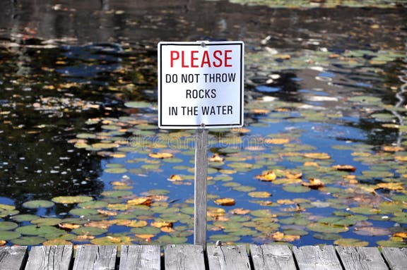 Please Do Not Throw Rocks in the Water Sign Stock Photo - Image of ...