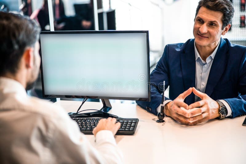 Pleased Customer Sitting in Front of a Manager Stock Image - Image of ...