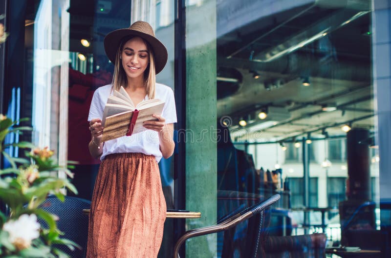 Pleased Female Reading Book Standing in Cafe Stock Photo - Image of ...