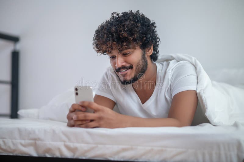 Pleased Young Man Reading a Text Message Stock Image - Image of device ...