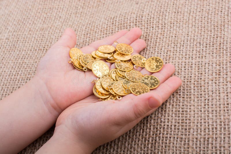 Plenty of Fake Gold Coins in Hand Stock Photo - Image of golden ...