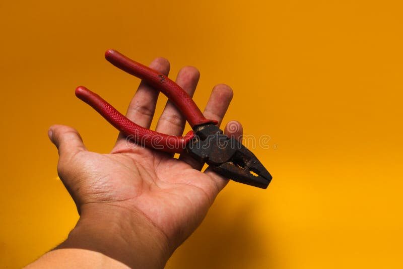Close-up View of Pliers on Hand Isolated on Orange Background Stock ...