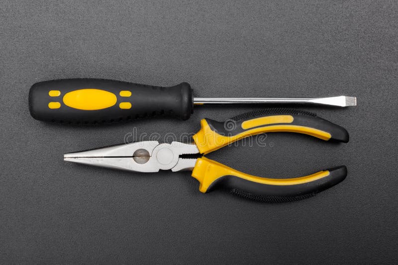 Pliers and Screwdriver on Black Stock Image - Image of blade, cutter ...