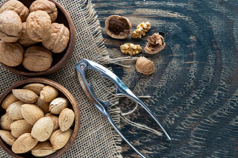 Pliers for Splitting Nuts and Assorted Nuts in a Wooden Bowls. Top View ...