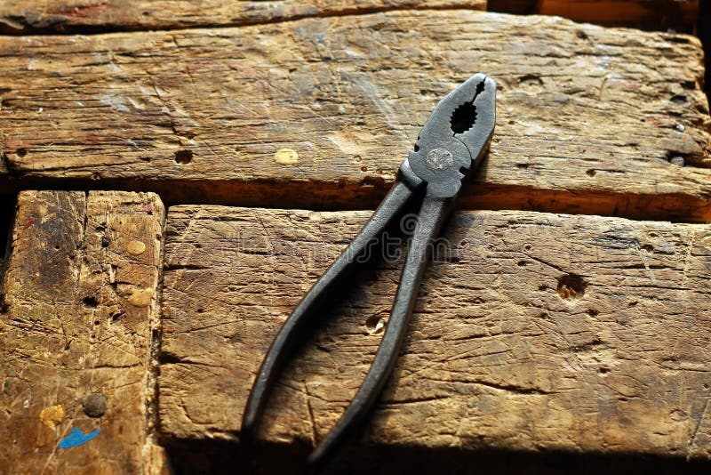 Pliers on the wooden table stock photo. Image of lineman - 50530412