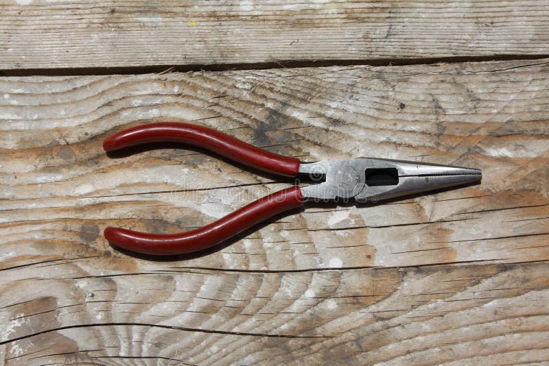 Pliers on wooden table stock image. Image of work, handle - 58757807