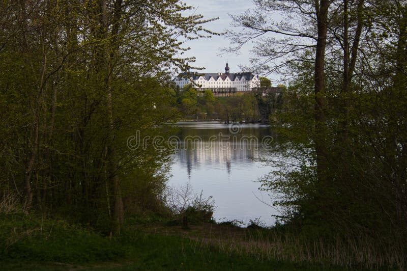 Plon Castle in Germany Reflected in Water between the Trees Stock Photo ...