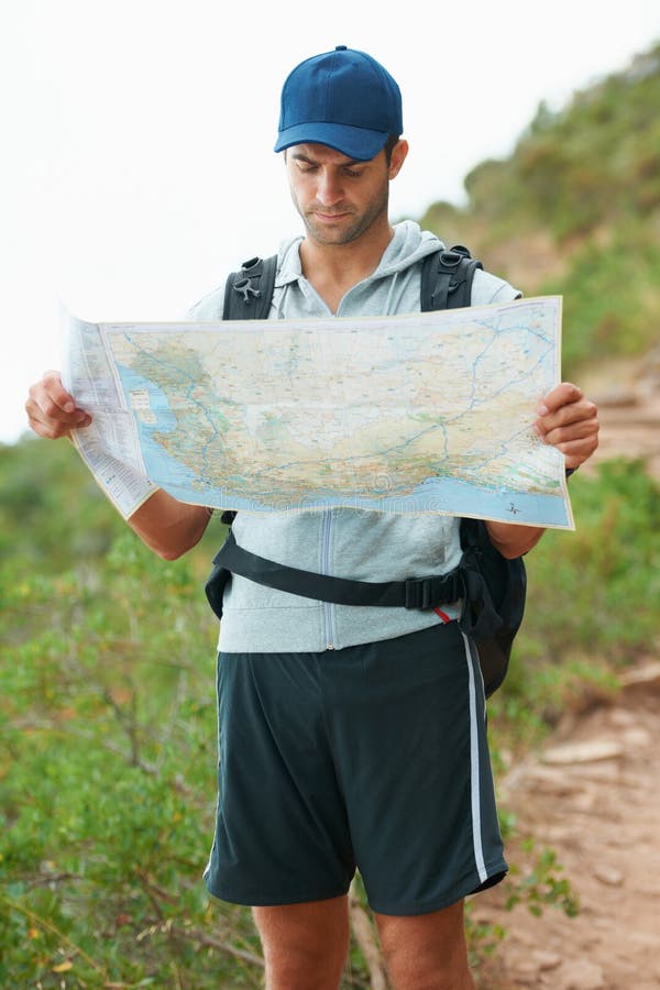 Plotting His Next Move. Handsome Young Hiker Reading a Map while ...
