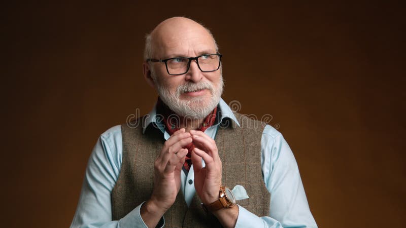Plotting Middle-Aged Man in Shirt and Waistcoat Against Brown Backdrop ...