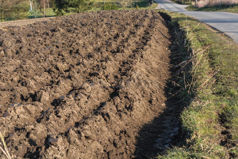 Plowed field with furrows stock image. Image of ground - 71790361