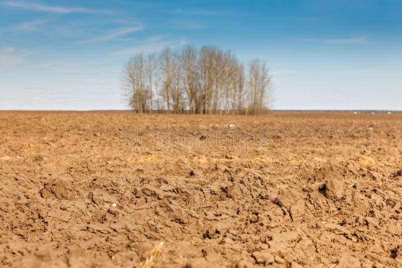 Plowed Field on a Background of Rural Houses Stock Photo - Image of ...