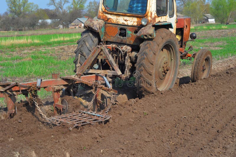 Plowing Field with Old Rustic Village Tractor. Stock Image - Image of ...