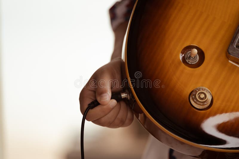 Plug Jack Cable in Electric Guitar,Hand Inserts Input Jack To Electric ...