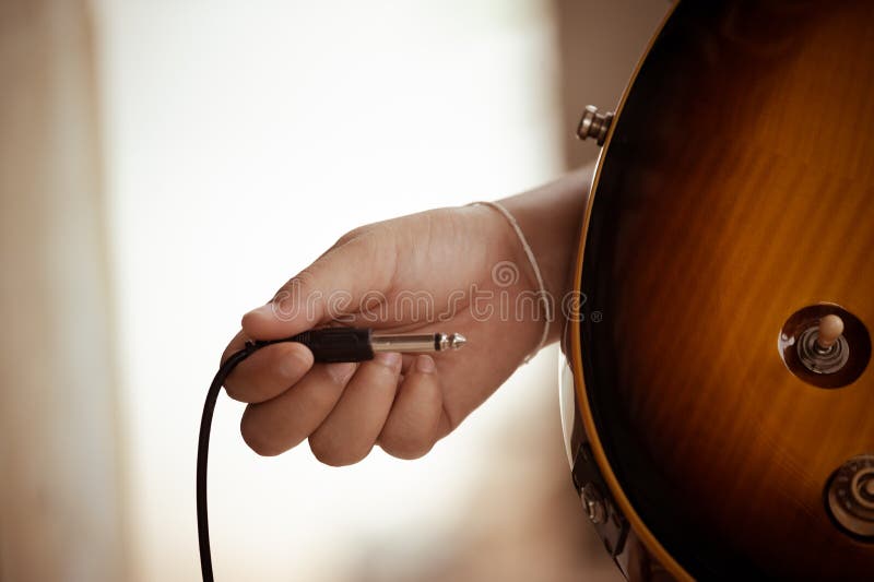 Plug Jack Cable in Electric Guitar,Hand Inserts Input Jack To Electric ...