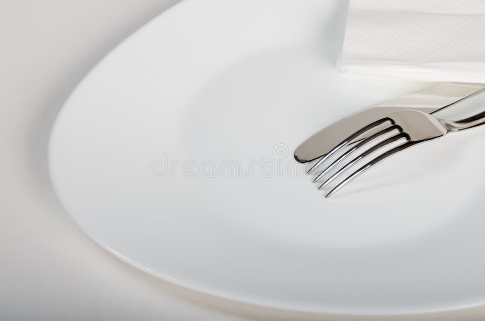 Plug and knife on a plate stock photo. Image of elegance - 27408132