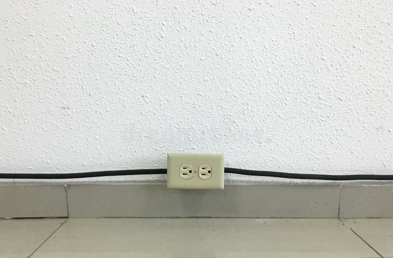 Plug in a white wall stock image. Image of technology - 155845433