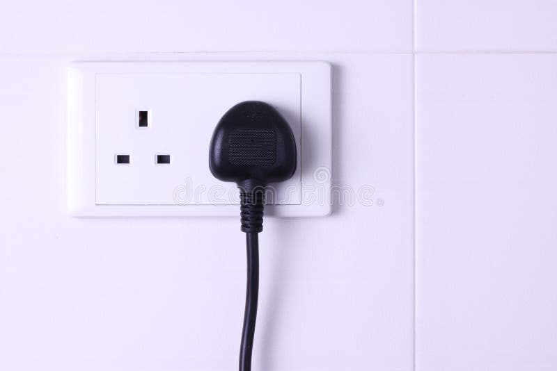 Plugged in Socket Against White Tiles Background Stock Image - Image of ...