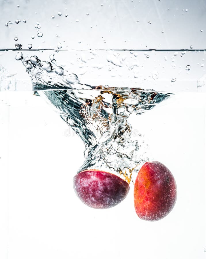 Plum in Water with Splash and Cut in Half Stock Photo - Image of plant ...