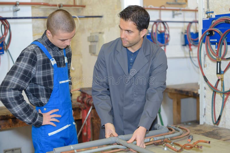 Plumber and Apprentice at Workshop Stock Image - Image of bolt, manual ...