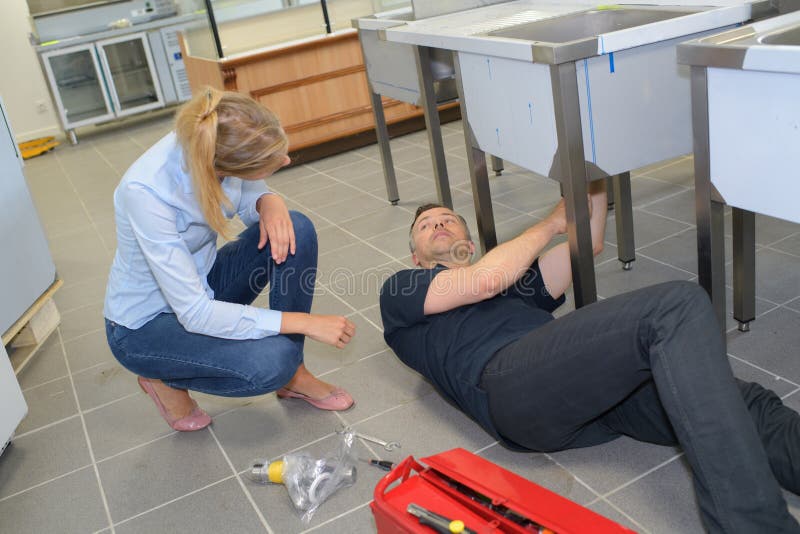 Plumber Carries Out Repair Work in Kitchen Stock Image - Image of ...