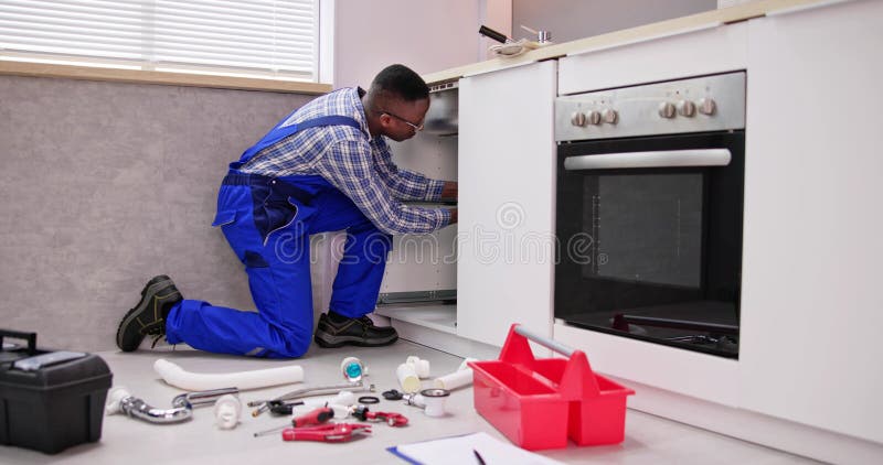 Plumber Cleaning Kitchen Drain and Pipe Stock Image - Image of house ...