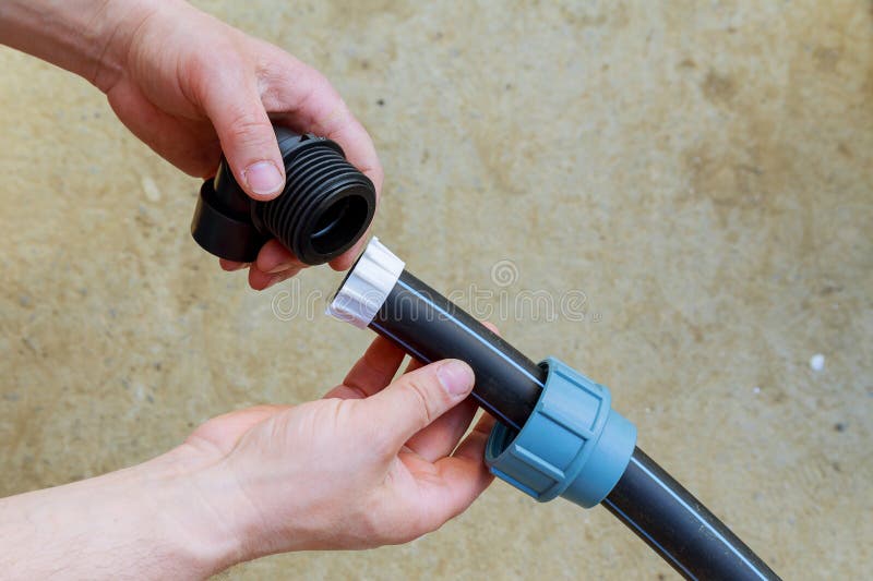 A Plumber Connects a Polyethylene Pipe Using a Special Fitting. Stock ...