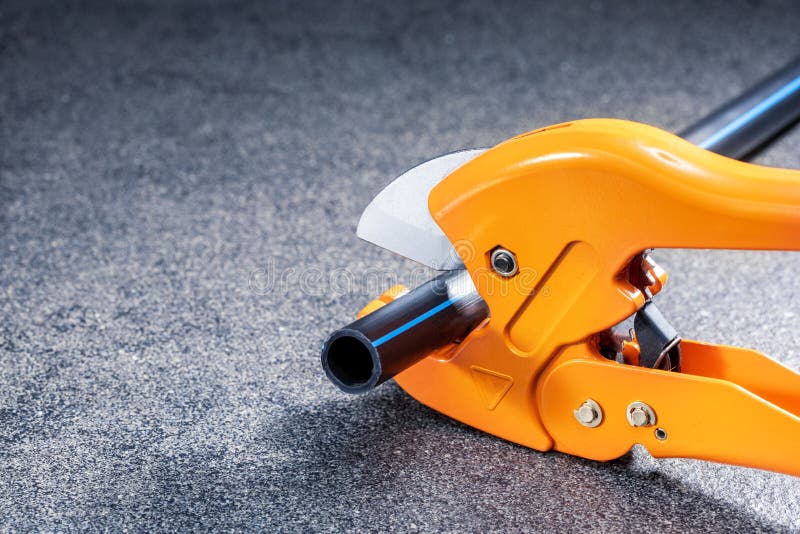 Plumber Cuts the Plastic Pipe Using a Cutter. Stock Photo - Image of ...