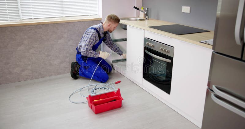 Plumber Drain Cleaning Services in Kitchen Stock Photo - Image of pipe ...