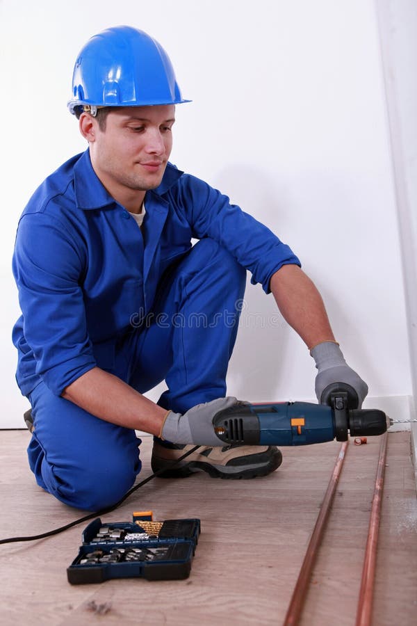 Plumber drilling stock image. Image of tools, kneeling - 35736559