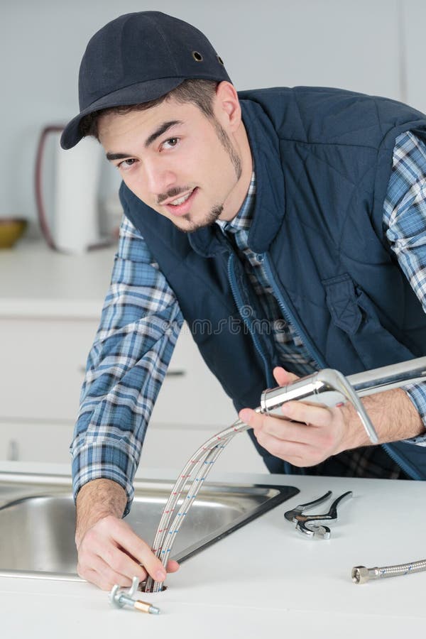Plumber fitting new tap stock photo. Image of profession - 264199140