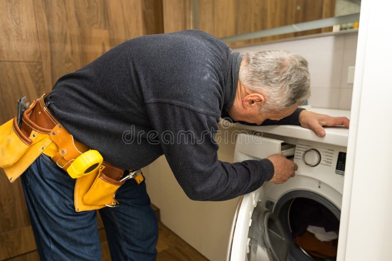 Plumber Fixing Domestic Washing Machine Stock Photo - Image of ...