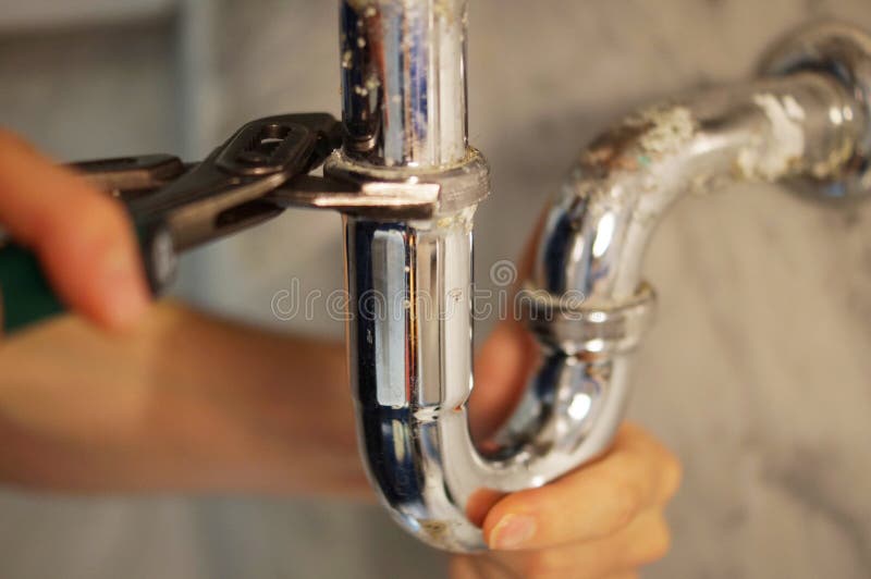 Plumber fixing drain stock image. Image of metal, interior - 207675531
