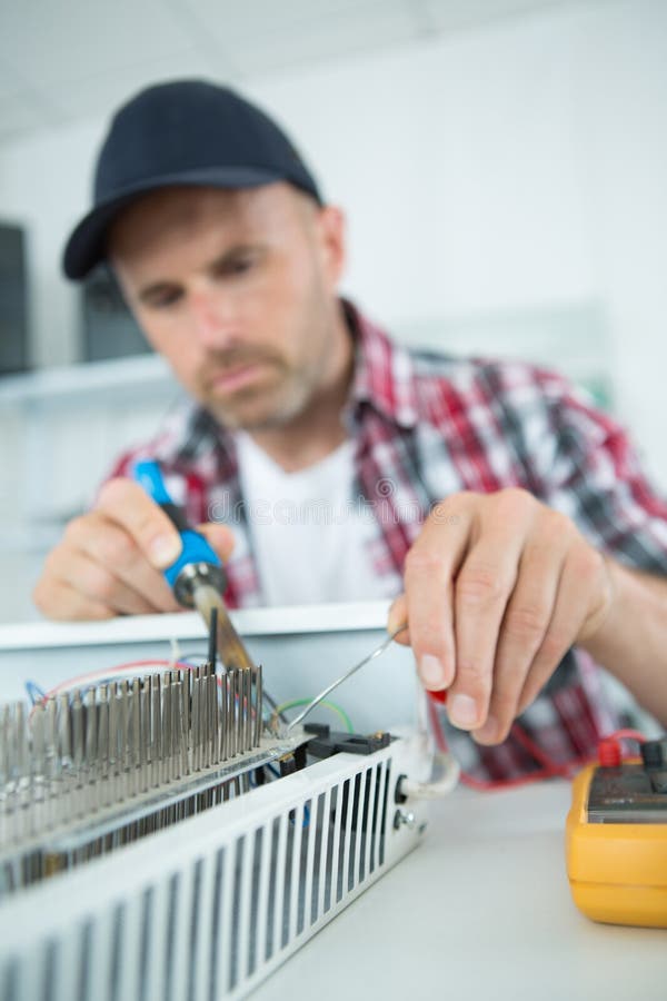 Plumber fixing a radiator stock image. Image of install - 130815687