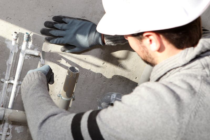 Plumber fixing some pipes stock photo. Image of occupation - 22485940
