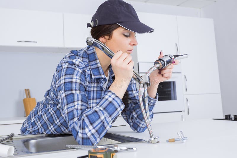 Plumber Fixing Tap with Adjustable Wrench Stock Photo - Image of woman ...