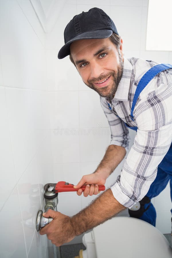 Plumber Fixing Tap with Wrench Stock Photo - Image of wrench, tile ...