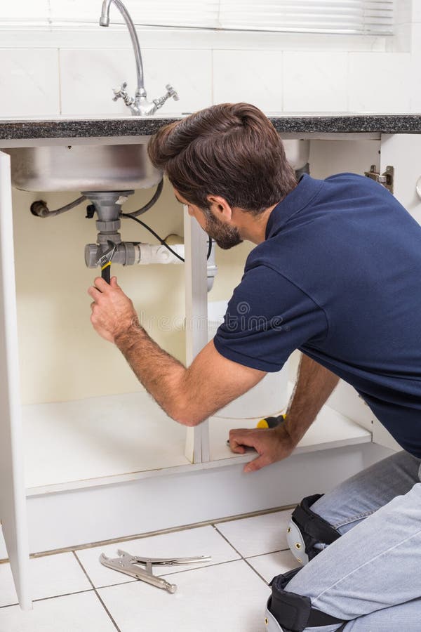 Plumber Fixing Under the Sink Stock Image - Image of sitting ...