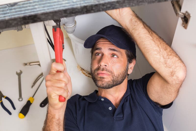 Plumber Fixing Under the Sink Stock Image - Image of adult, thoughtful ...