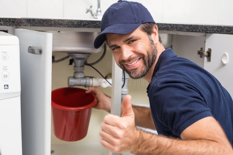 Plumber Fixing Under the Sink Stock Photo - Image of happy, tool: 47015390